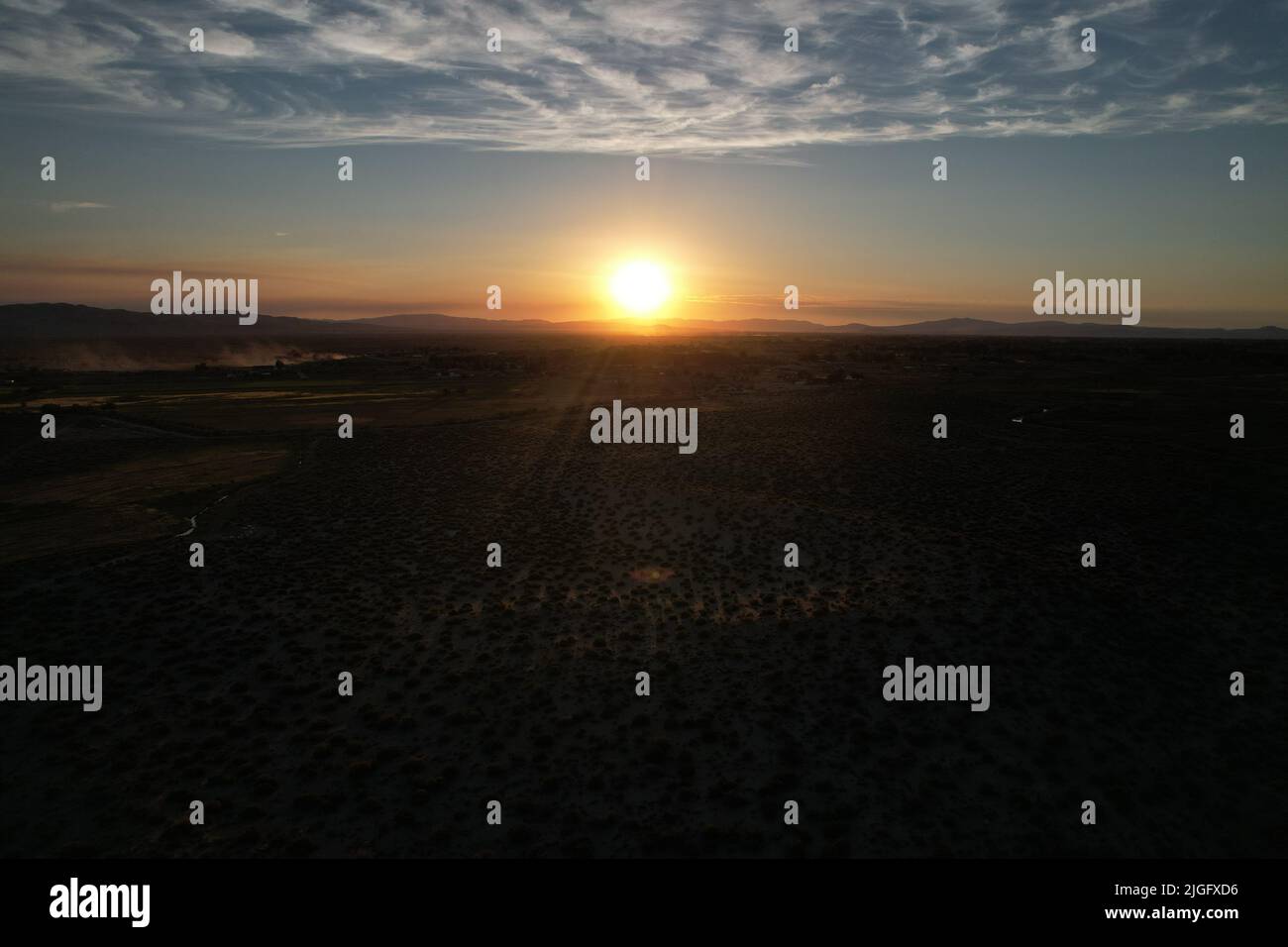 Desert sunset showing of the whole of a small farming town Stock Photo ...