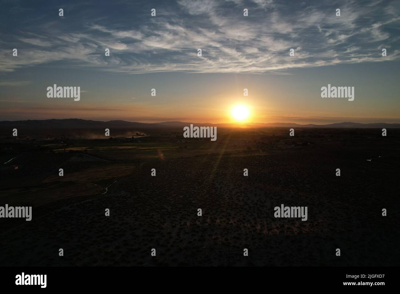 Desert sunset showing of the whole of a small farming town Stock Photo ...
