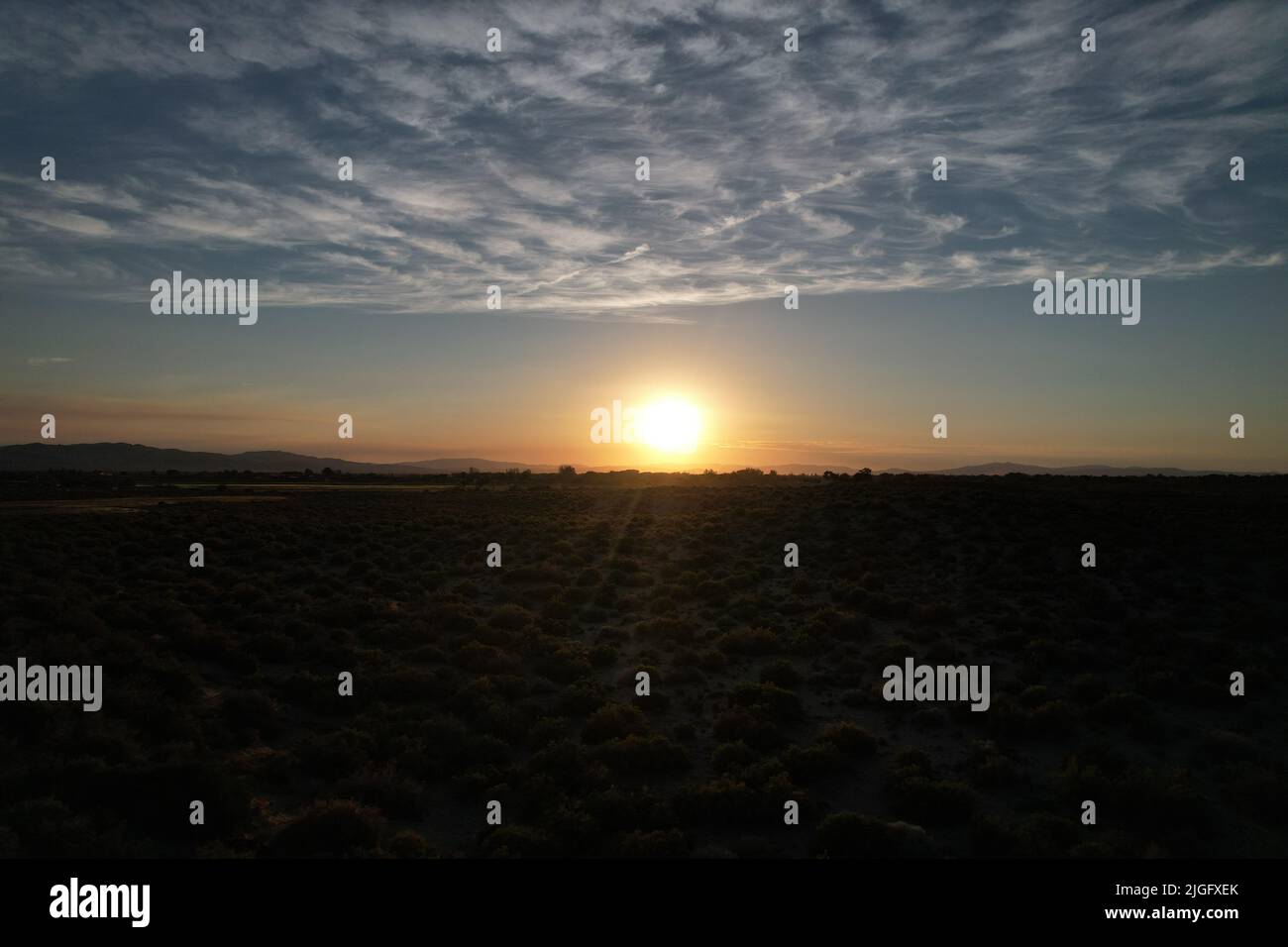 Desert sunset showing of the whole of a small farming town Stock Photo ...