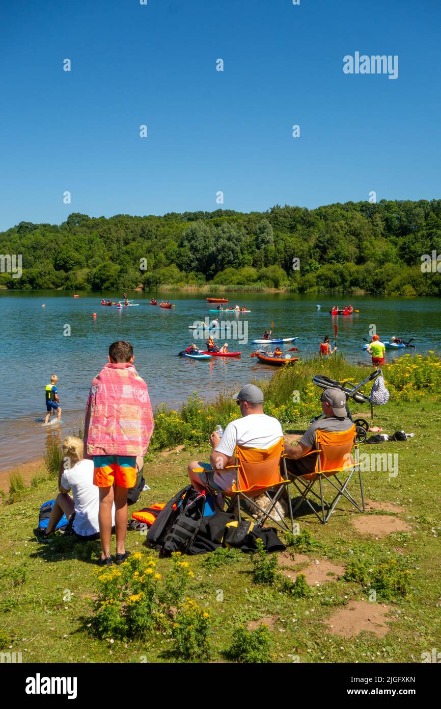 People and families enjoying the summer sunshine at Astbury Mere water ...