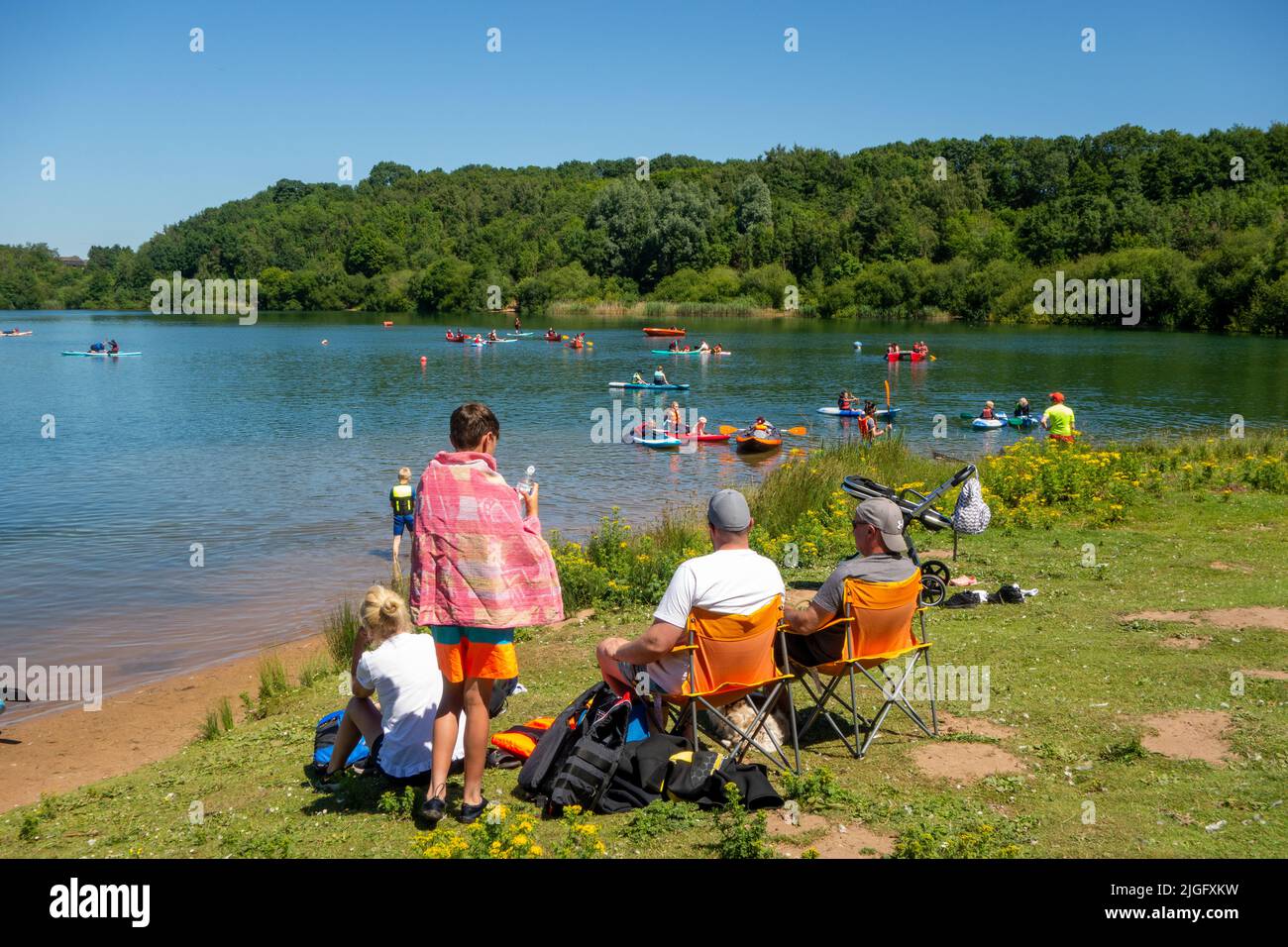 People and families enjoying the summer sunshine at Astbury Mere water ...