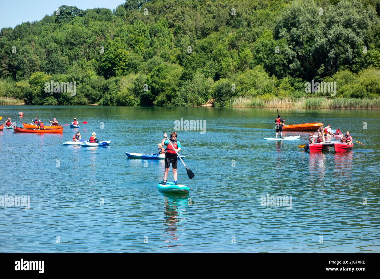 People and families enjoying the summer sunshine at Astbury Mere water ...