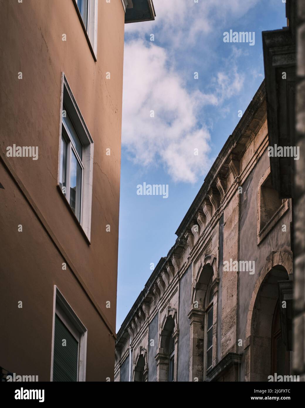 A low angle shot of upper floors and roofs of old buildings Stock Photo ...