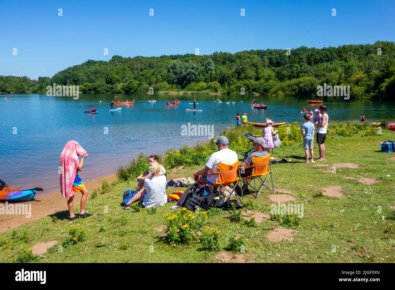 People and families enjoying the summer sunshine at Astbury Mere water ...