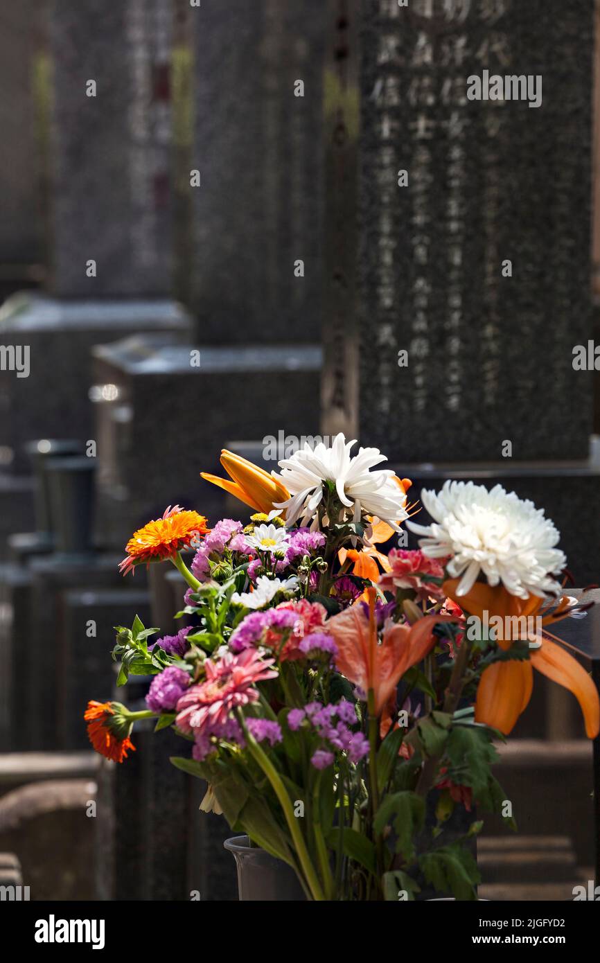 Flowers on memorial marker cemetery Shinshoji Temple Nakaikegami Tokyo ...