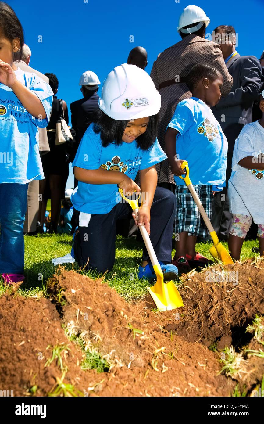 A vertical shot of African kids digging at an event at the Nelson ...