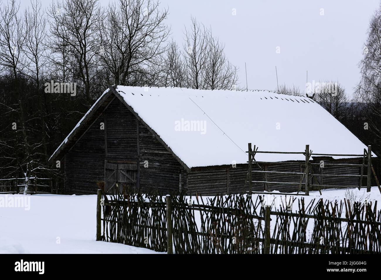 An old wooden hut. Abandoned Russian village covered in snow. Log house ...