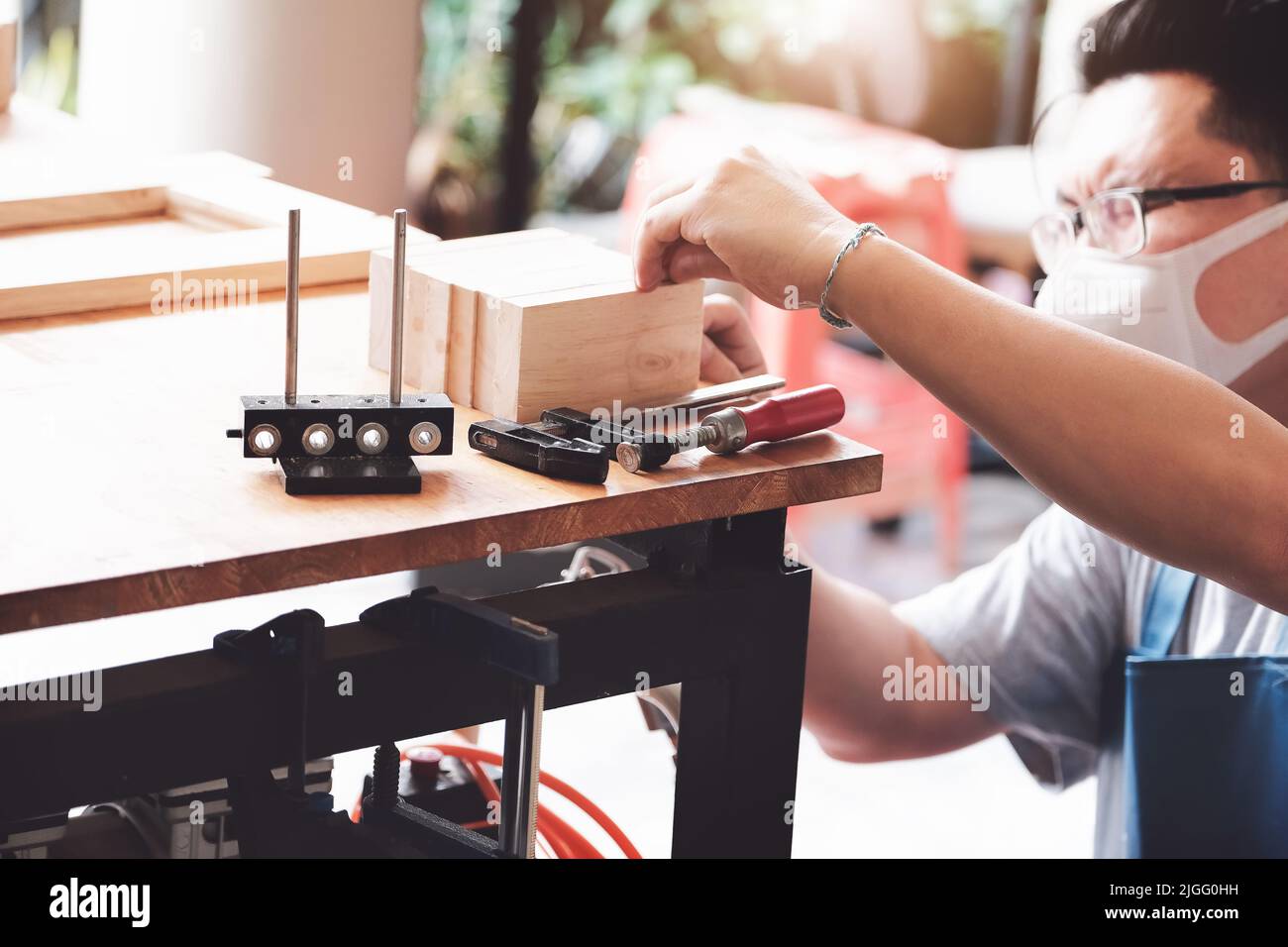 A carpenter measures the planks to assemble the parts, and build a ...