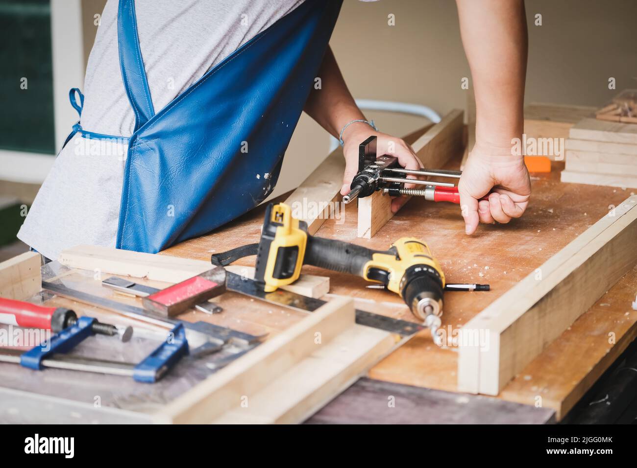Woodworking operators are using woodworking tools to prepare a drill ...