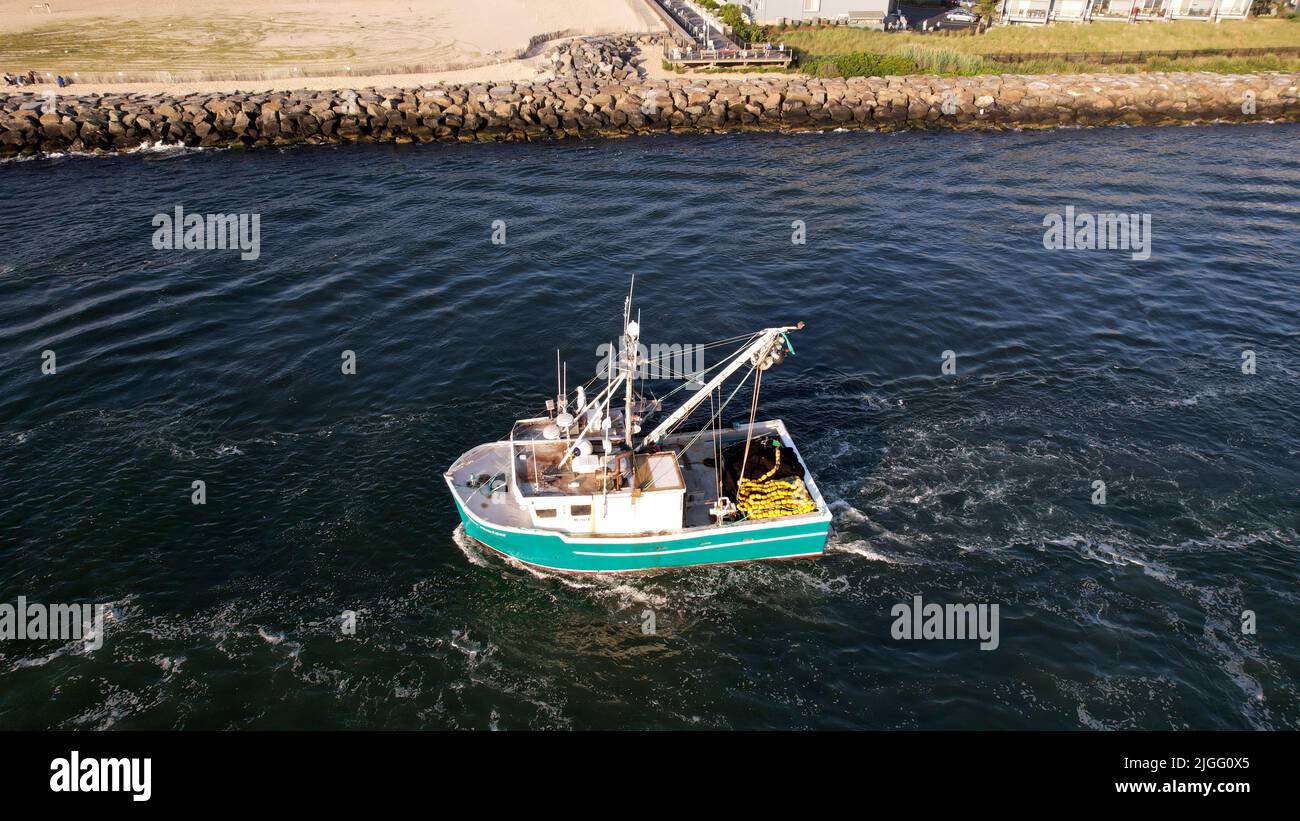Aerial view of boat along the Manasquan Inlet heading to the Atlantic ...
