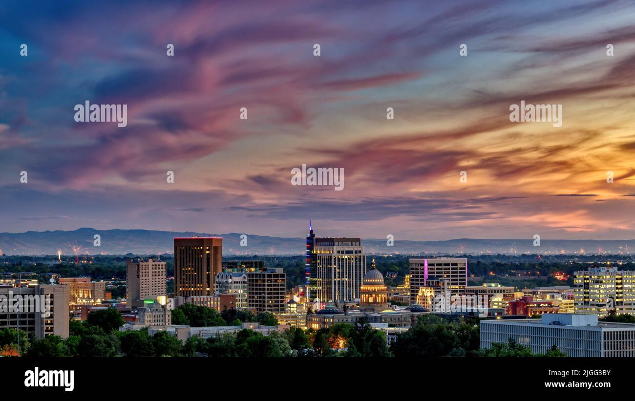 Fireworks speckle the horizon as the sun goes down over Boise Idaho ...