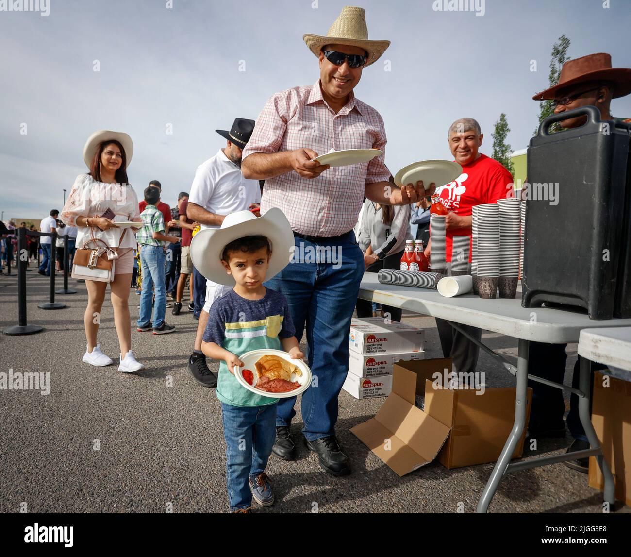 Calgary, Canada. 10th July, 2022. Families take in a pancake breakfast ...