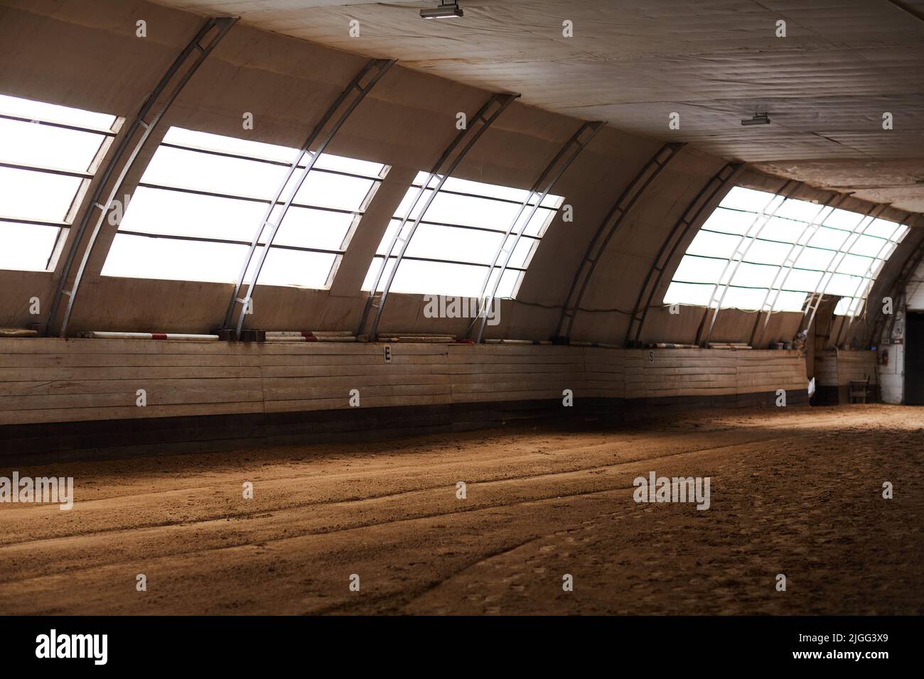 Background image of empty indoor riding arena at horse ranch in ...