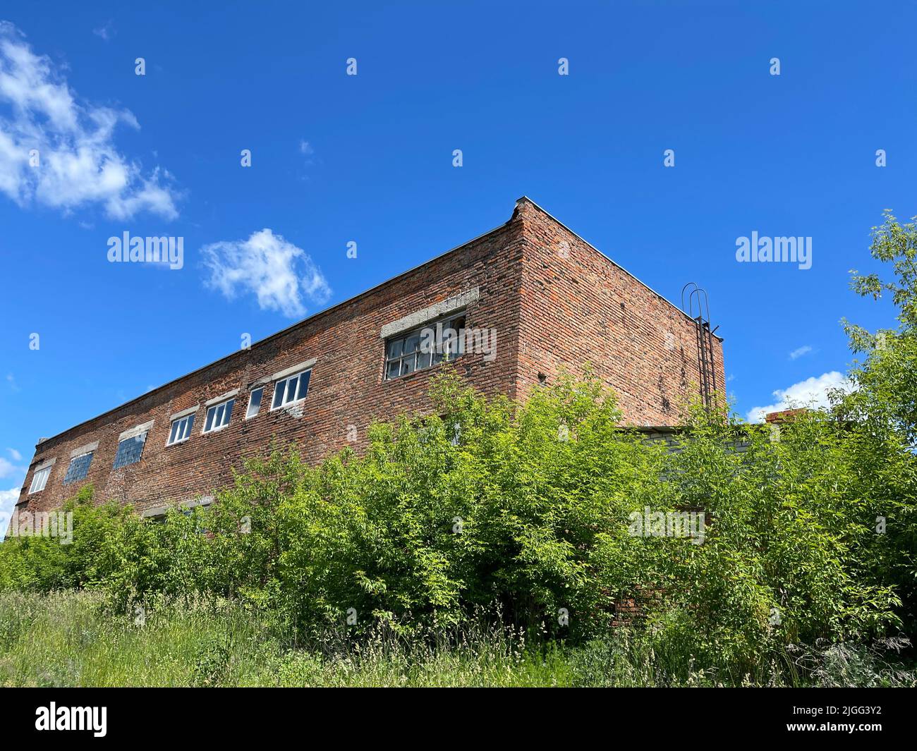 Old brick industrial building in sunny weather. Building exterior of ...