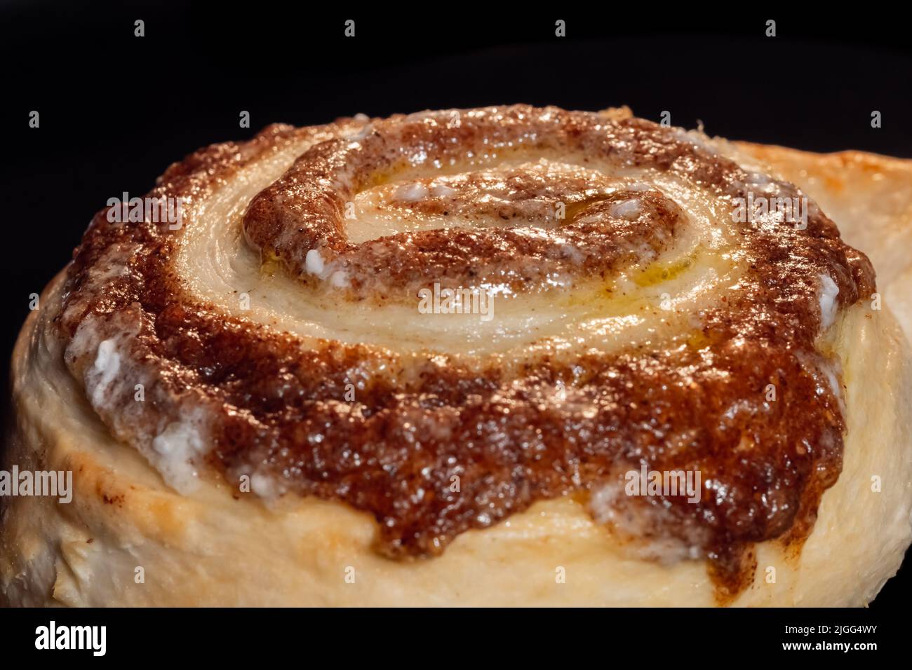 One cinnamon bun baking and rising in electric oven Stock Photo - Alamy