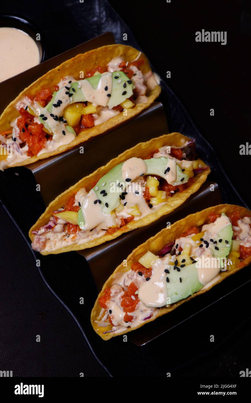 mexican style food taco with seafood and chicken in a serving stand ...