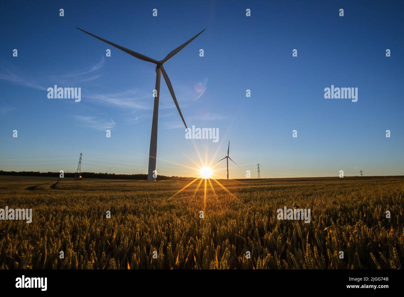 Wind turbines in operation as the sun sets over Hook Moor Wind Farm in ...