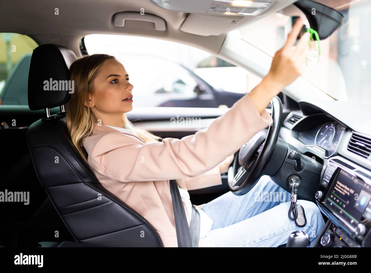 woman car summer city parking lot, looks rear view mirror, parks ...