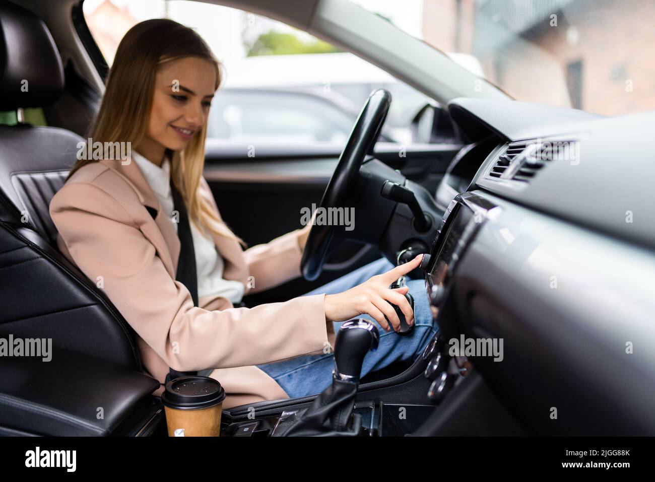 woman changing radio station while driving car Stock Photo - Alamy