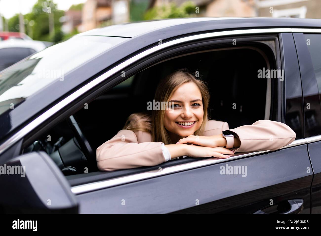 Beautiful young happy smiling woman driving her car Stock Photo - Alamy