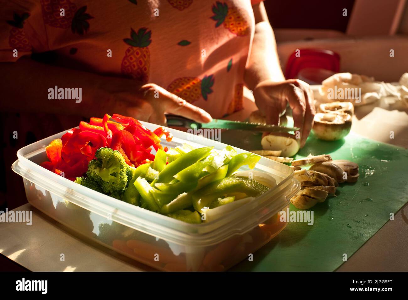 Woman in kitchen chopping vegetables on counter Stock Photo - Alamy