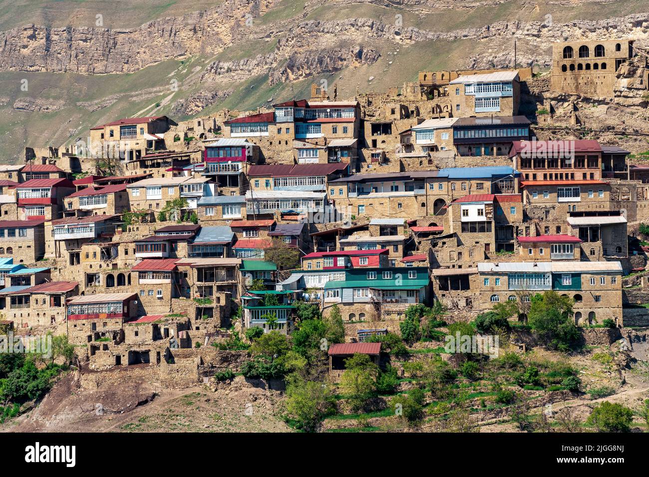 facades of houses located in tiers on a steep slope in the village of ...