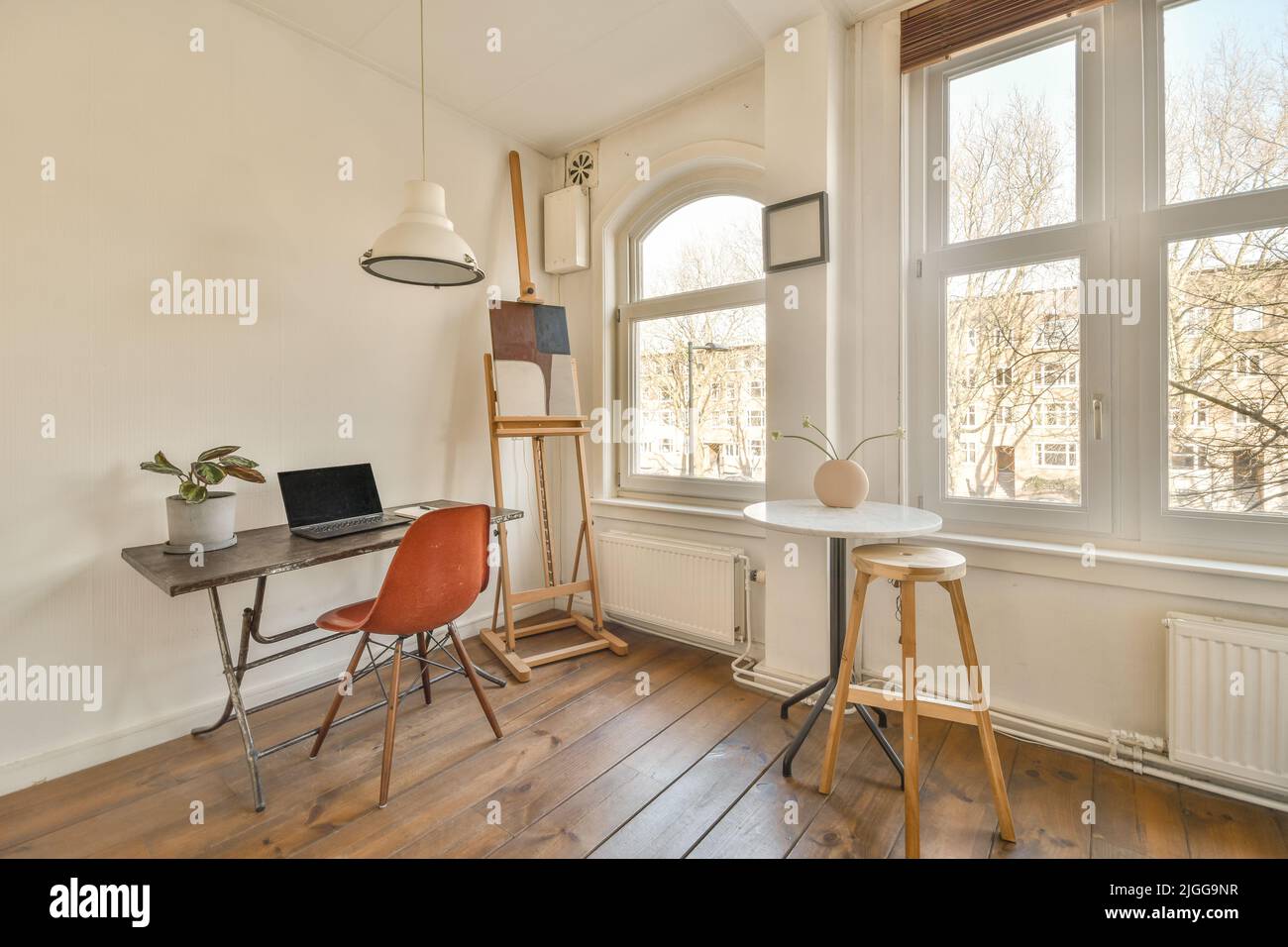 Table with chairs and comfortable sofa located in in spacious room with ...