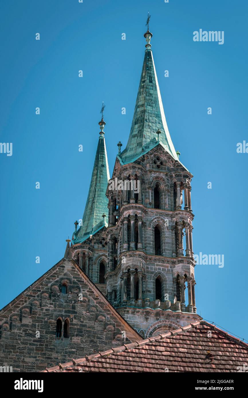 The rooftop and tower of an old church against a clear blue sky Stock ...