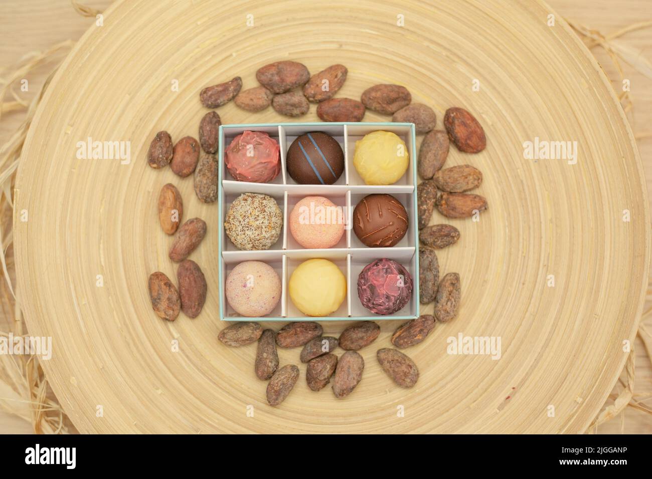 A top view shot of a box of round gourmet chocolates with different ...