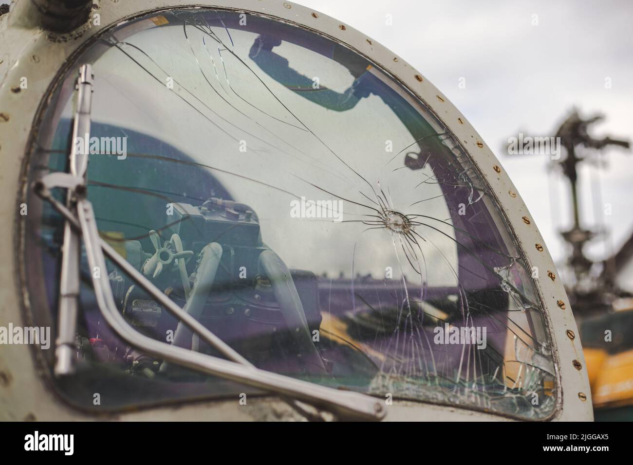 A closeup shot of bullet holes on the glass of a MI24 helicopter Stock ...