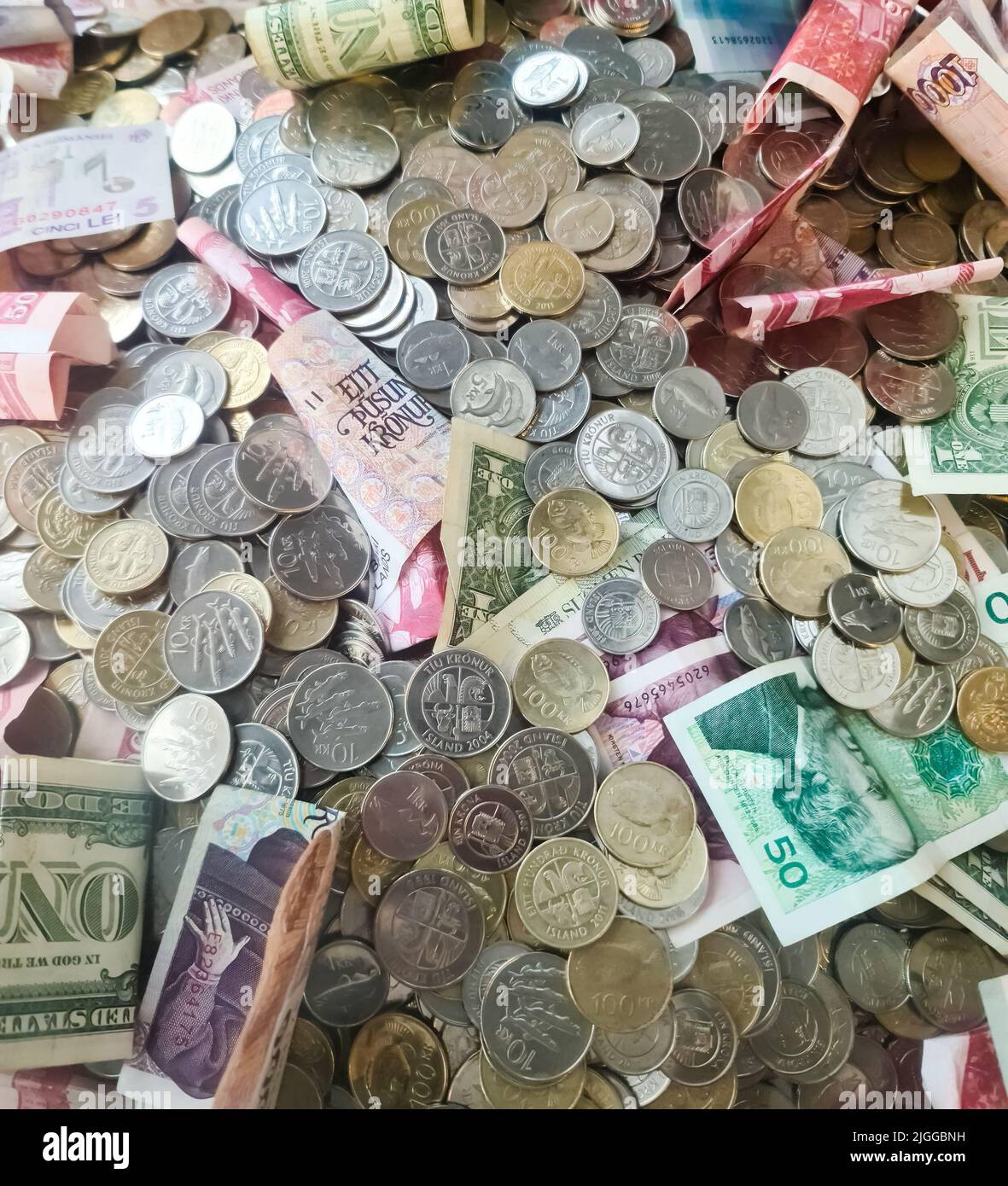 A lot of Icelandic coins and banknotes mixed with other currencies ...