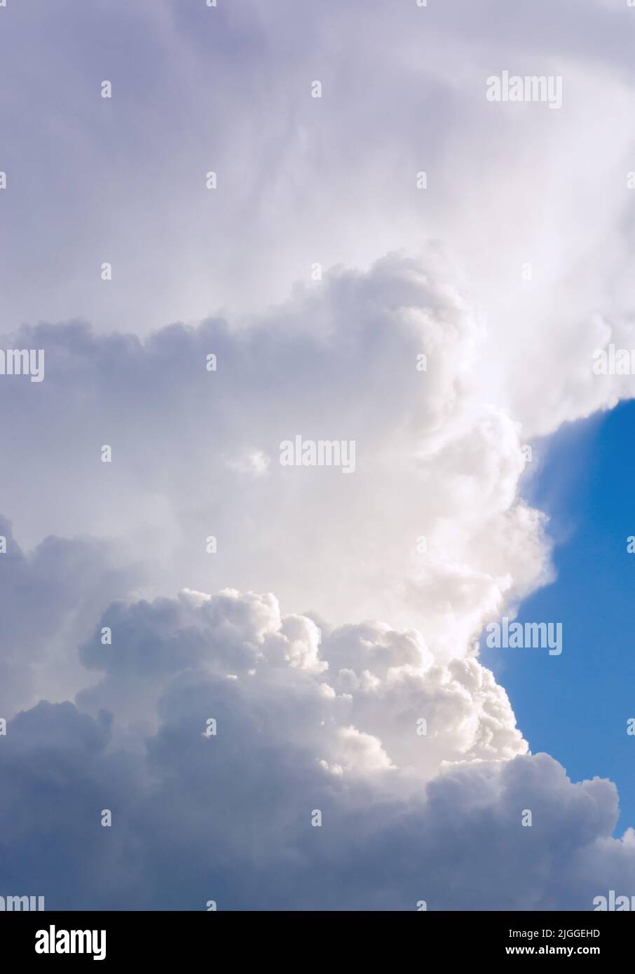 Sky with several layers of dark cumulus clouds, in vertical format ...