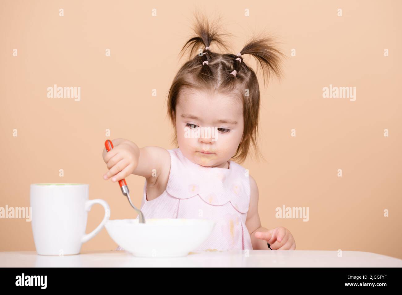 Cute baby food, babies eating. Portrait of cute Caucasian child kid ...