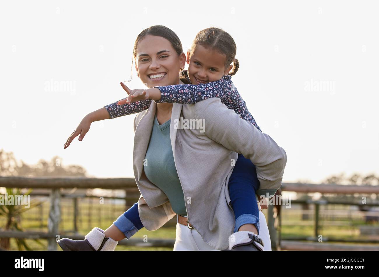 Fun childhood days down at the farm. an adorable little girl enjoying a ...