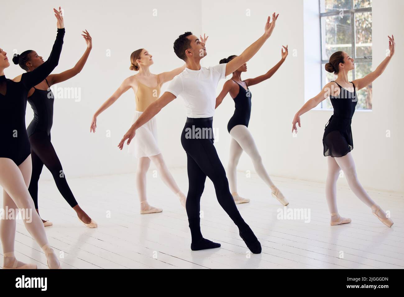 Dance for yourself. a group of ballet dancers practicing a routine in a ...