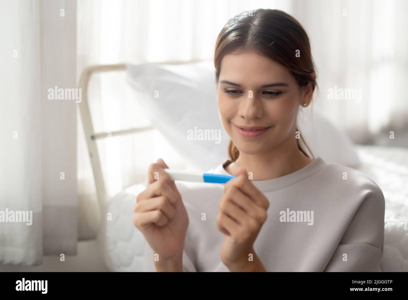 Happiness young asian woman taking pregnancy test while excited and ...