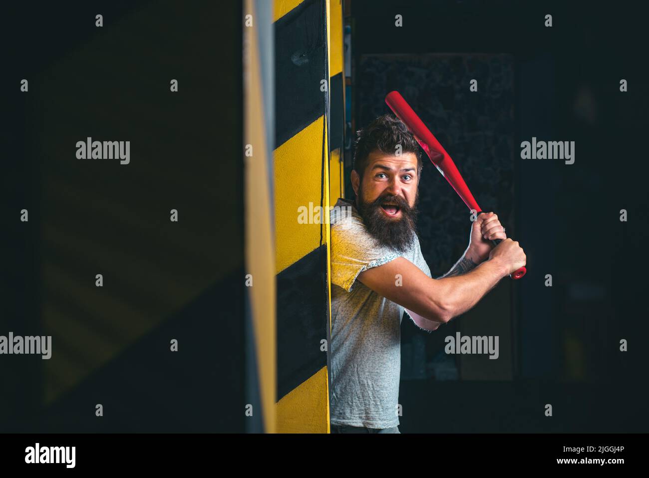 Portrait of danger aggressive man fighting with bat. Gang crime attack ...