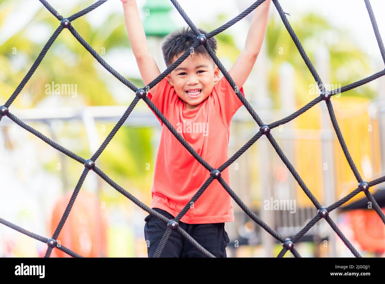 Asian child smiling playing climbing outdoor playground, happy ...