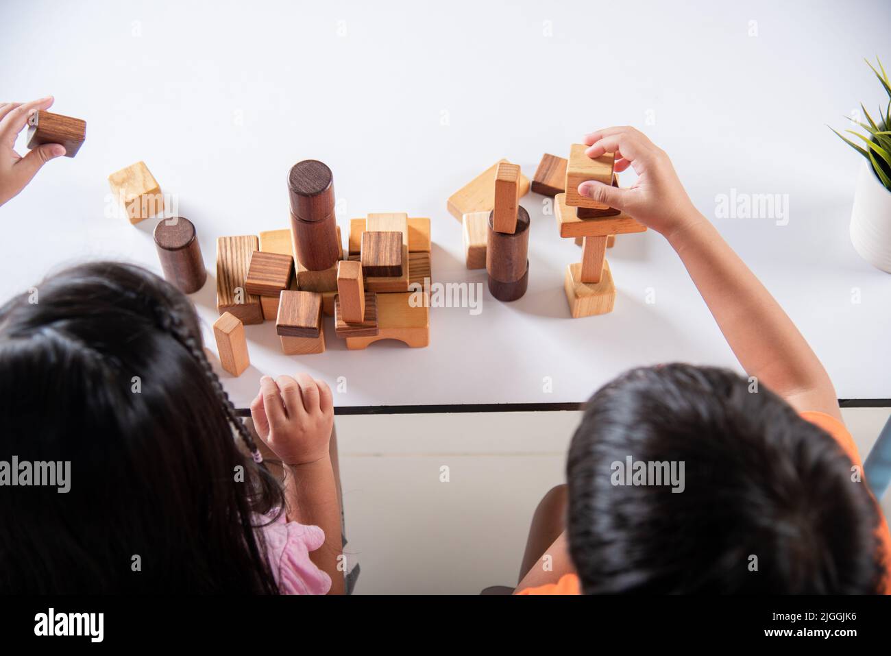 Happy little kids play wood block stacking board game at home, Children ...