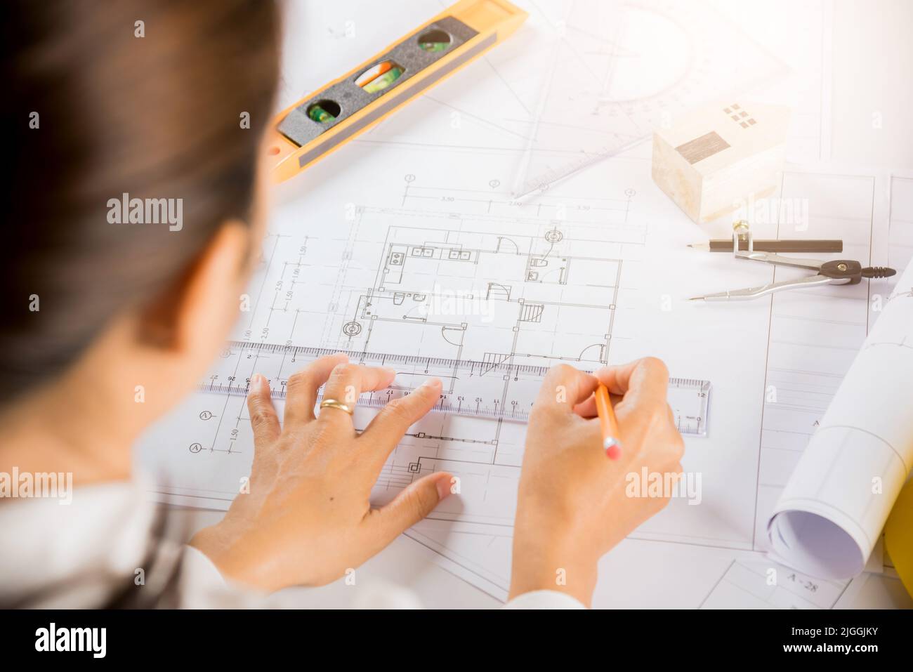 Architectural project workplace. Architect drawing with ruler on house ...