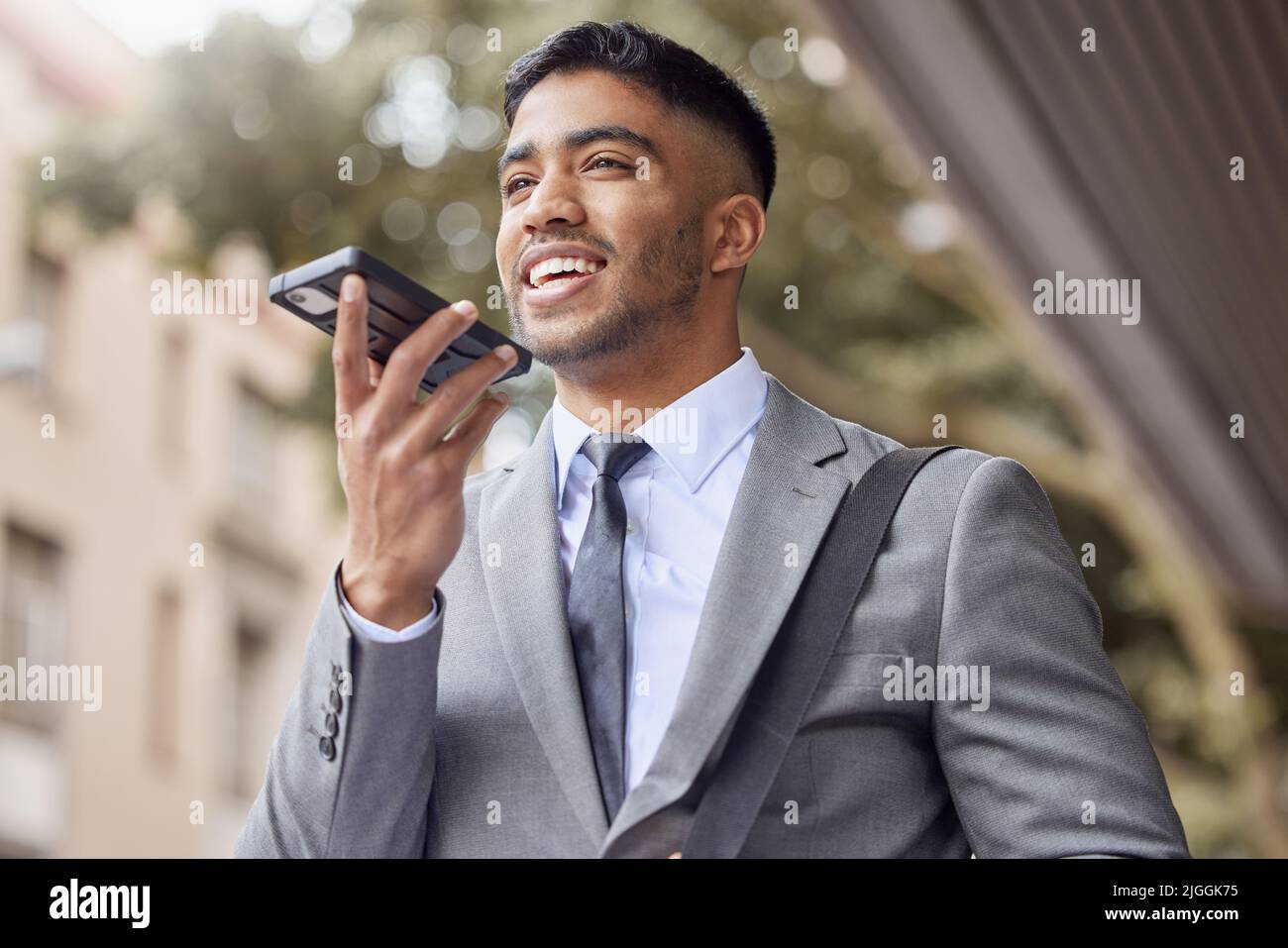 I prefer to send voice notes. a handsome young businessman walking ...