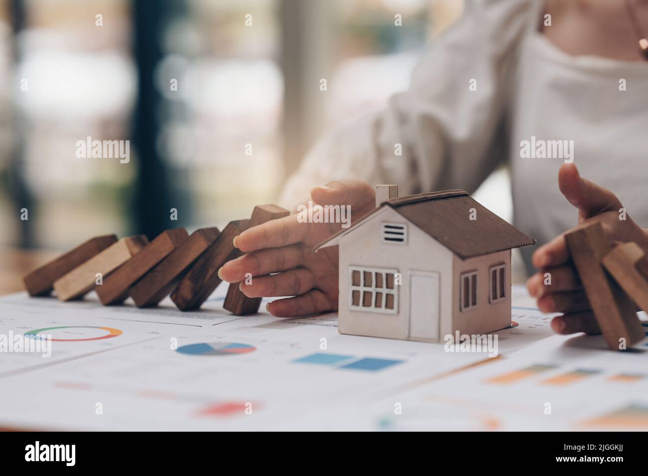 Real estate and insurance concept. Agent using hand symbol to protect ...