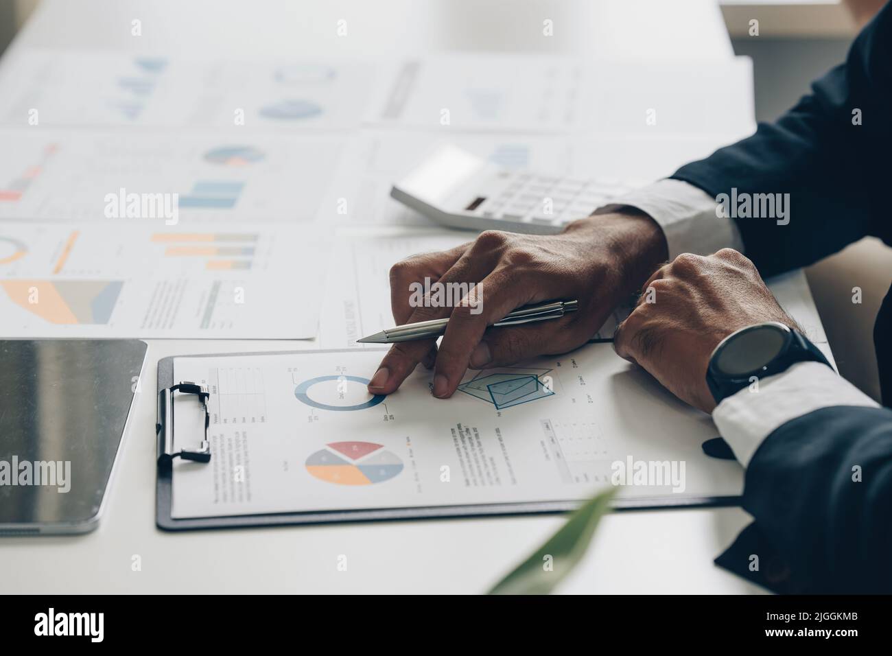 Consult financial concept. Businessman pointing at paperwork and using ...