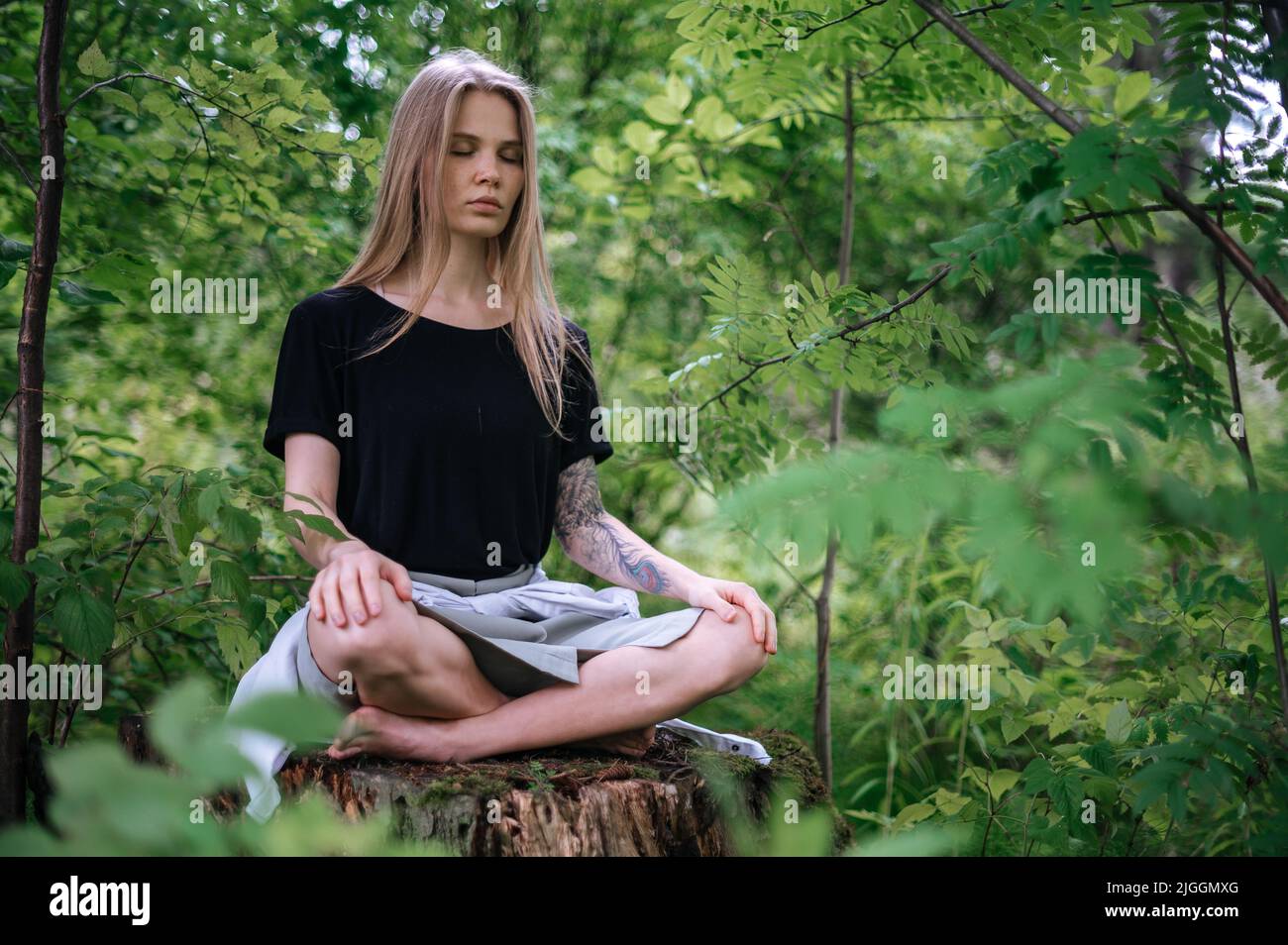 Practice of meditation and interaction with nature. Girl in green ...