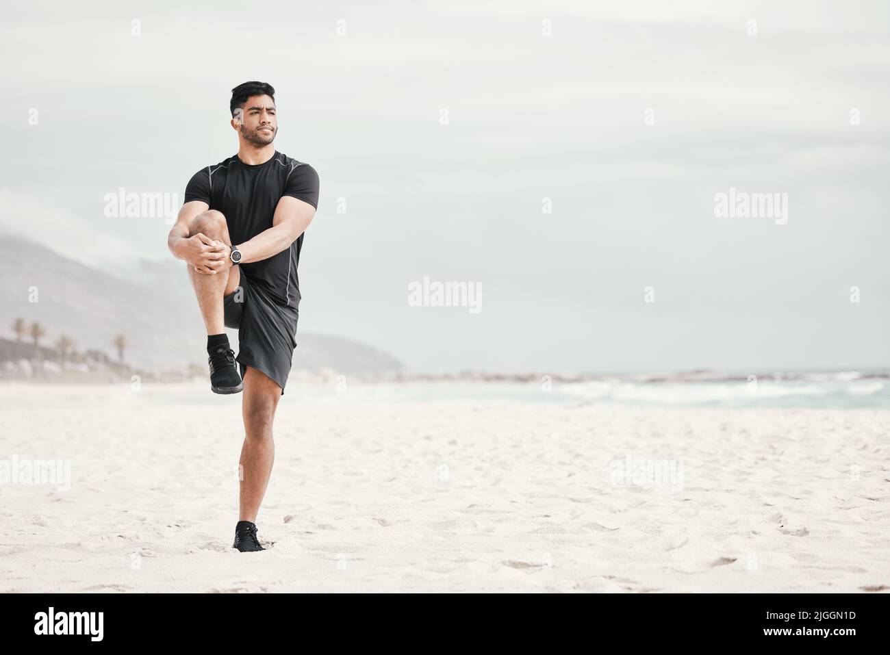 Stretch your day by starting it with a workout. a young man stretching ...