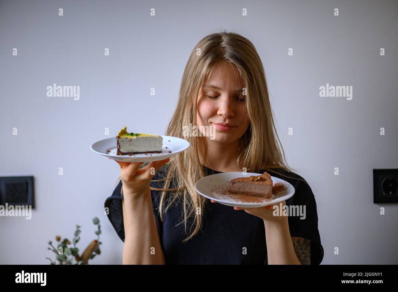 Girl holds a plates of vegan cakes. Cashewcakes Stock Photo - Alamy