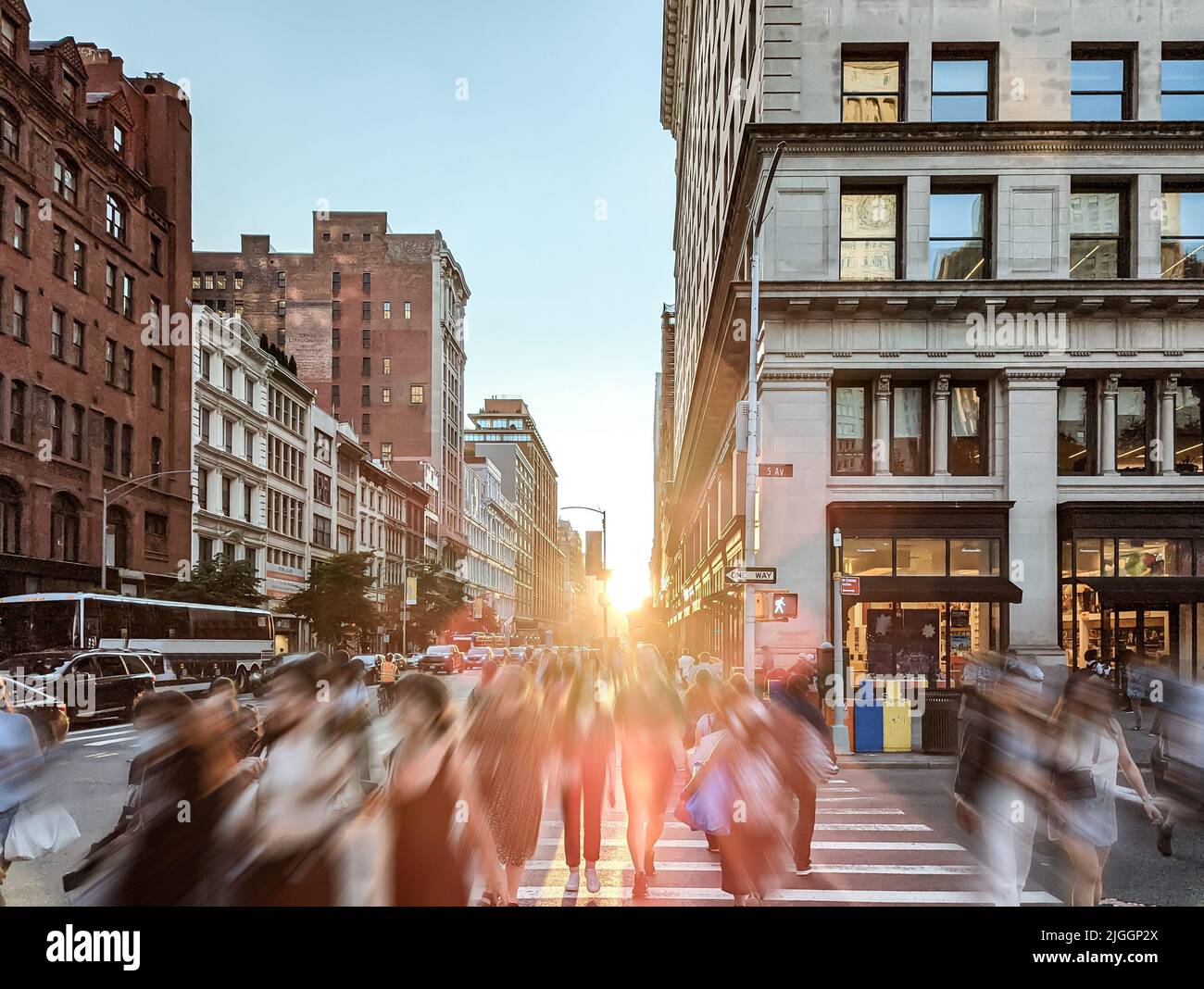 Crowds of people walking across a busy street intersection on 5th ...