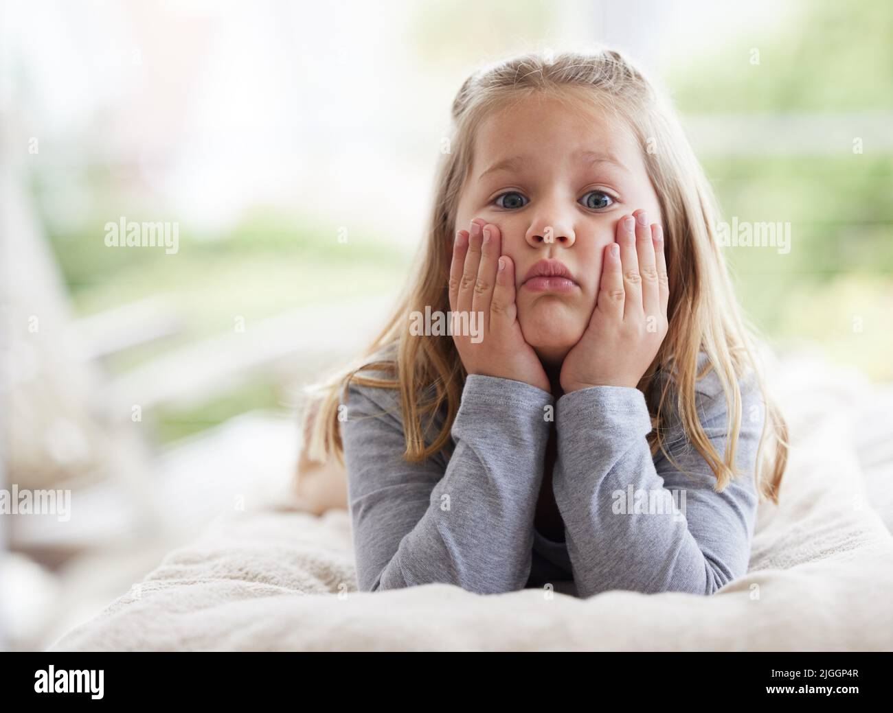 Im so bored what can I do. a young girl relaxing in her bedroom Stock ...