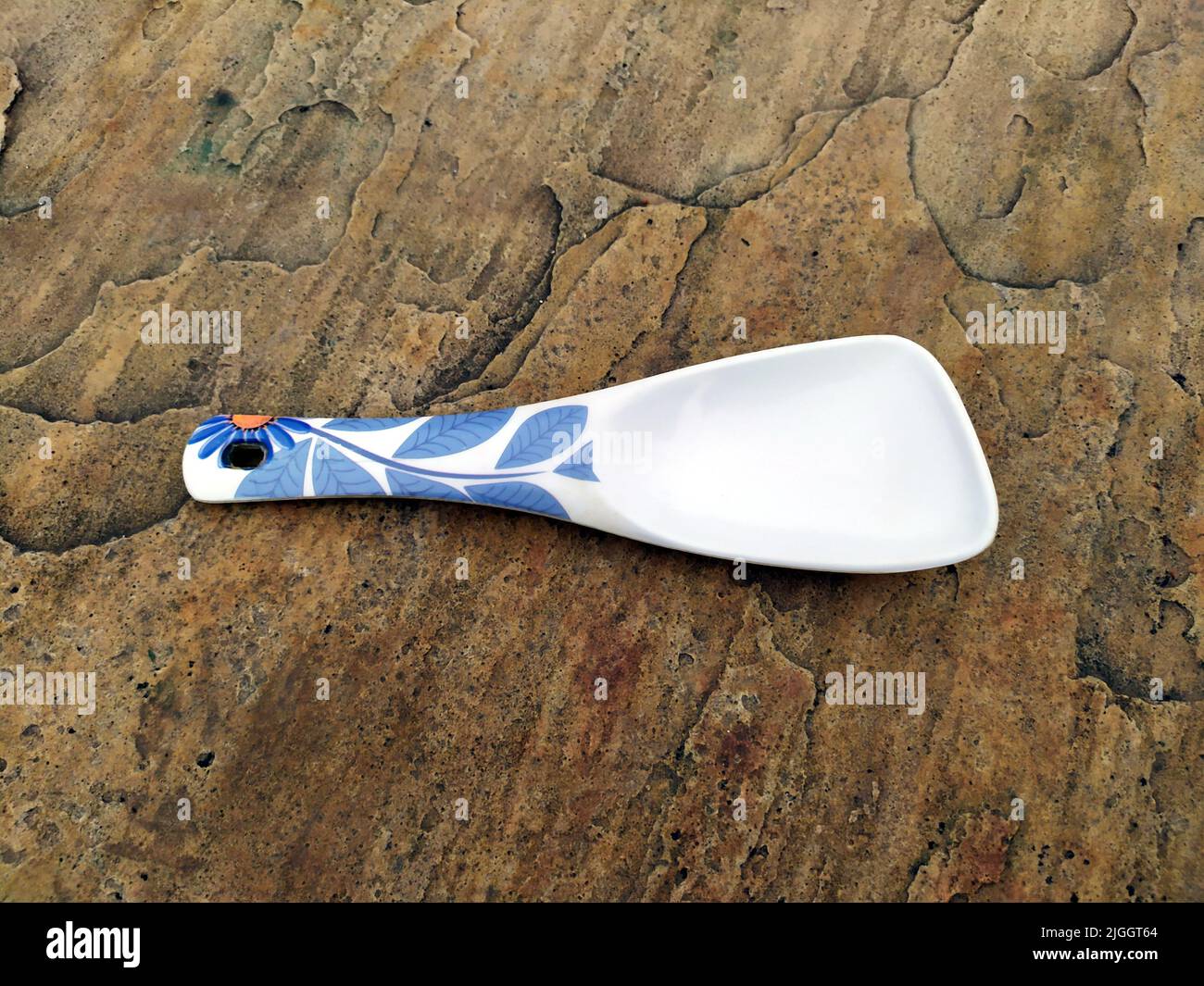 a big spoon on stone background Stock Photo - Alamy