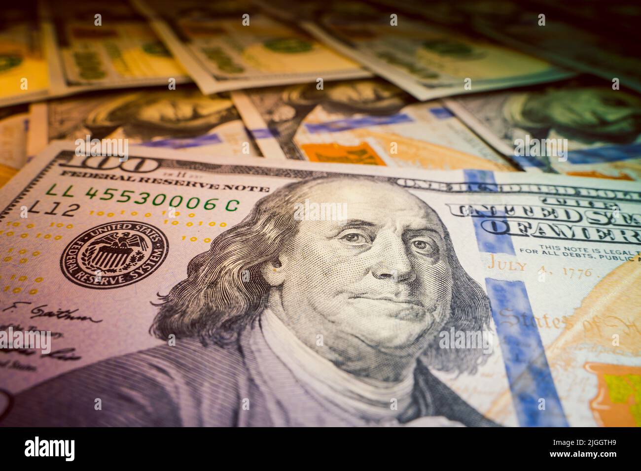 Close-up beautiful clean new one hundred dollar bill lies on other one ...